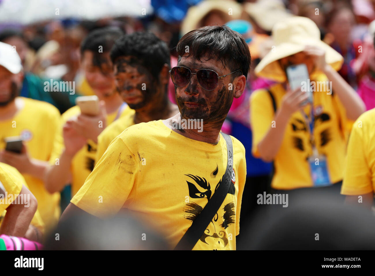 Chinese people of the Yi ethnic group daub their faces black to ...