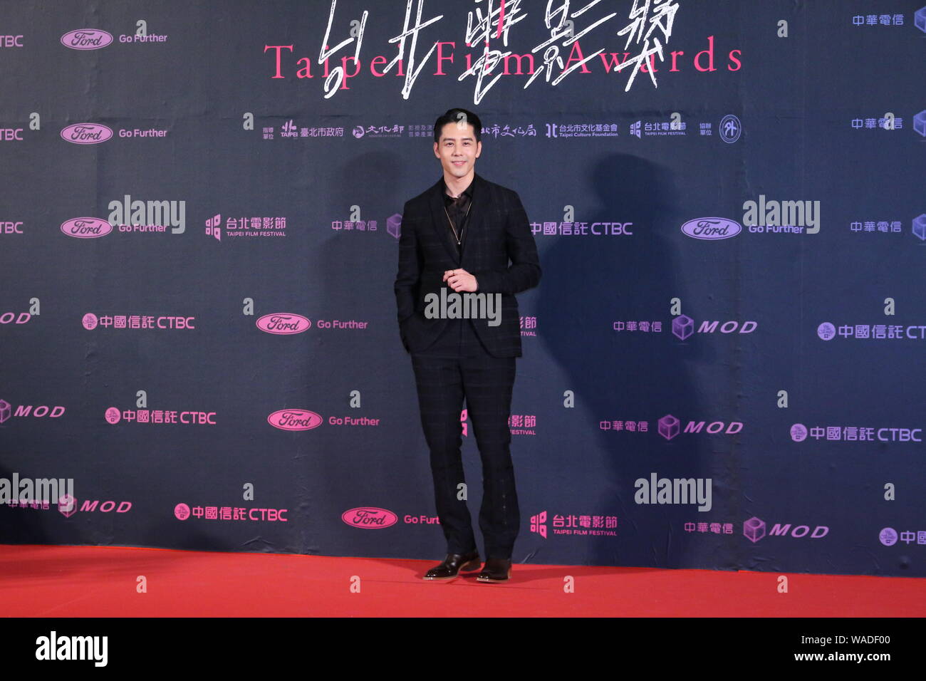 American-born actor and singer George Hu poses as he arrives on the red ...
