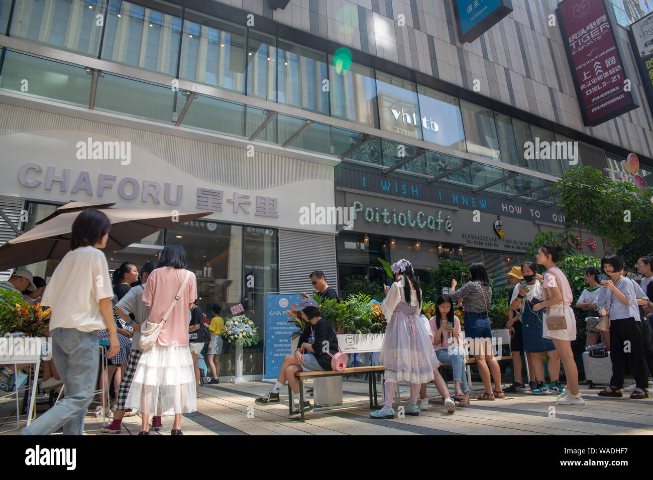Chinese fans wait in a long queue in front of a milk tea store operated ...