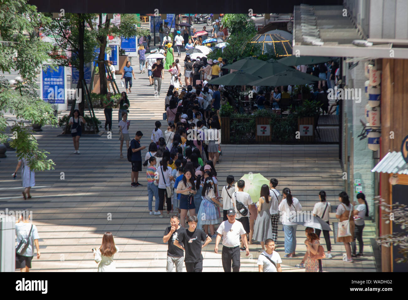 Chinese fans wait in a long queue in front of a milk tea store operated ...