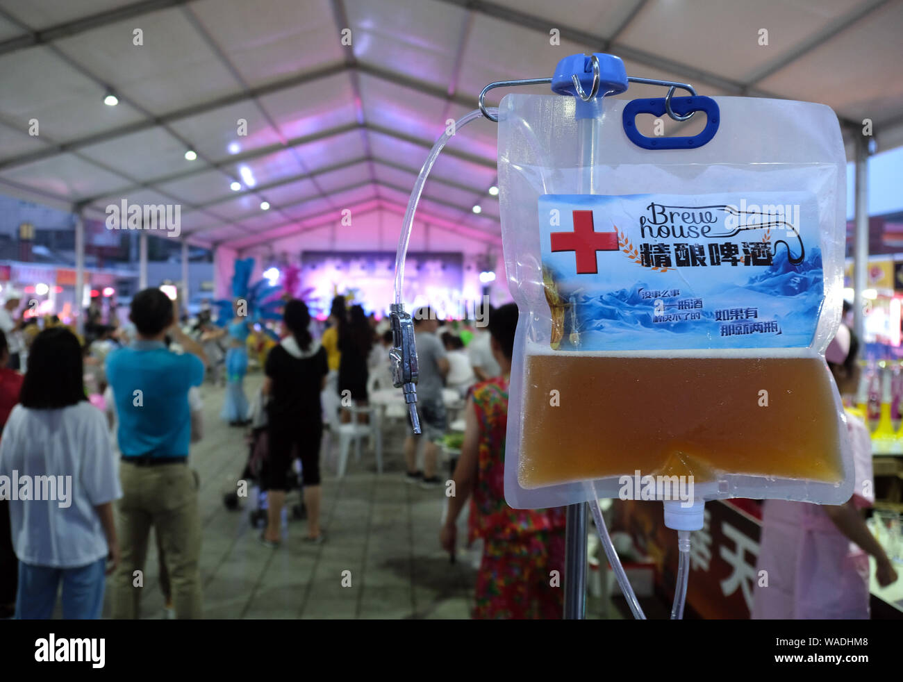 An infusion bag filled with beer is hanging at a beer bar in Shenyang ...