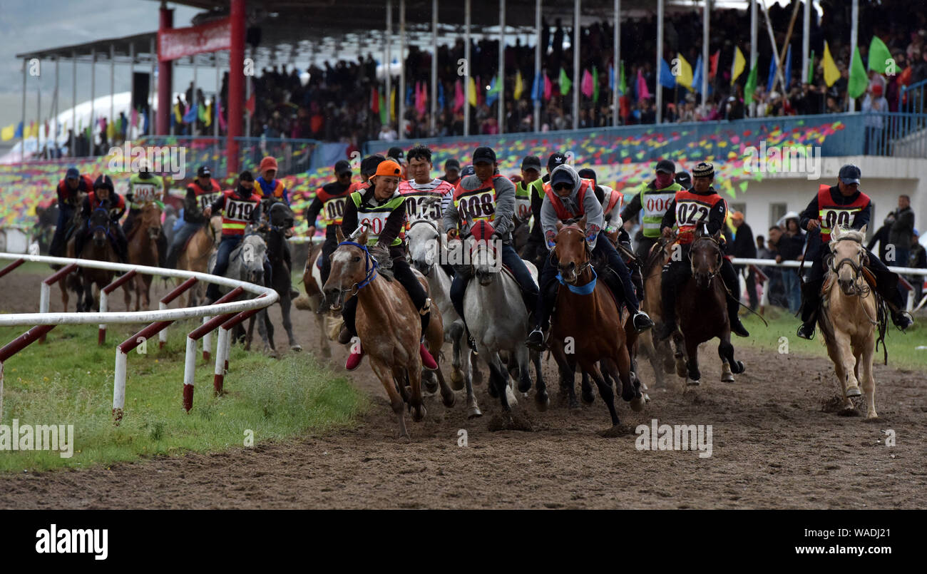 Participants ride horses during the Naadam Festival in Hejing county ...