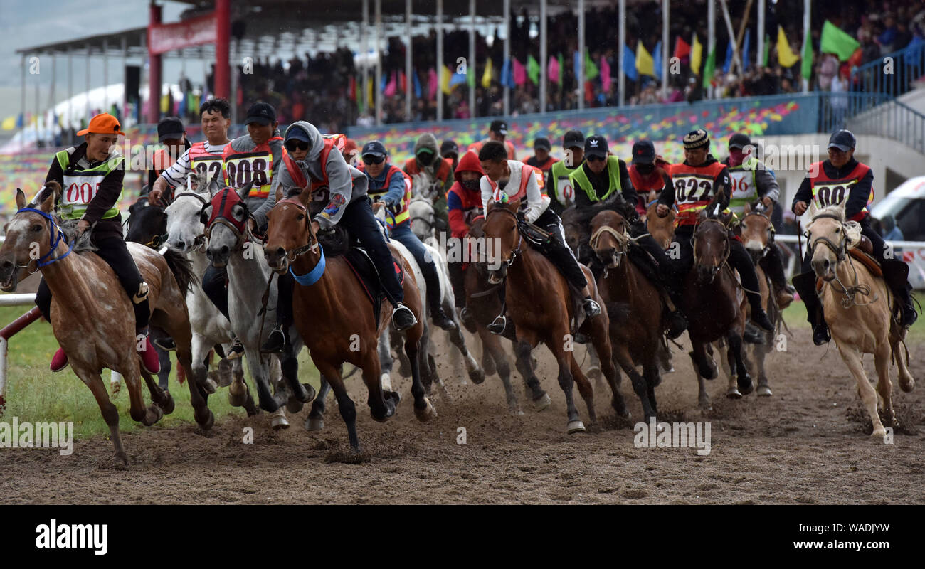Participants ride horses during the Naadam Festival in Hejing county ...