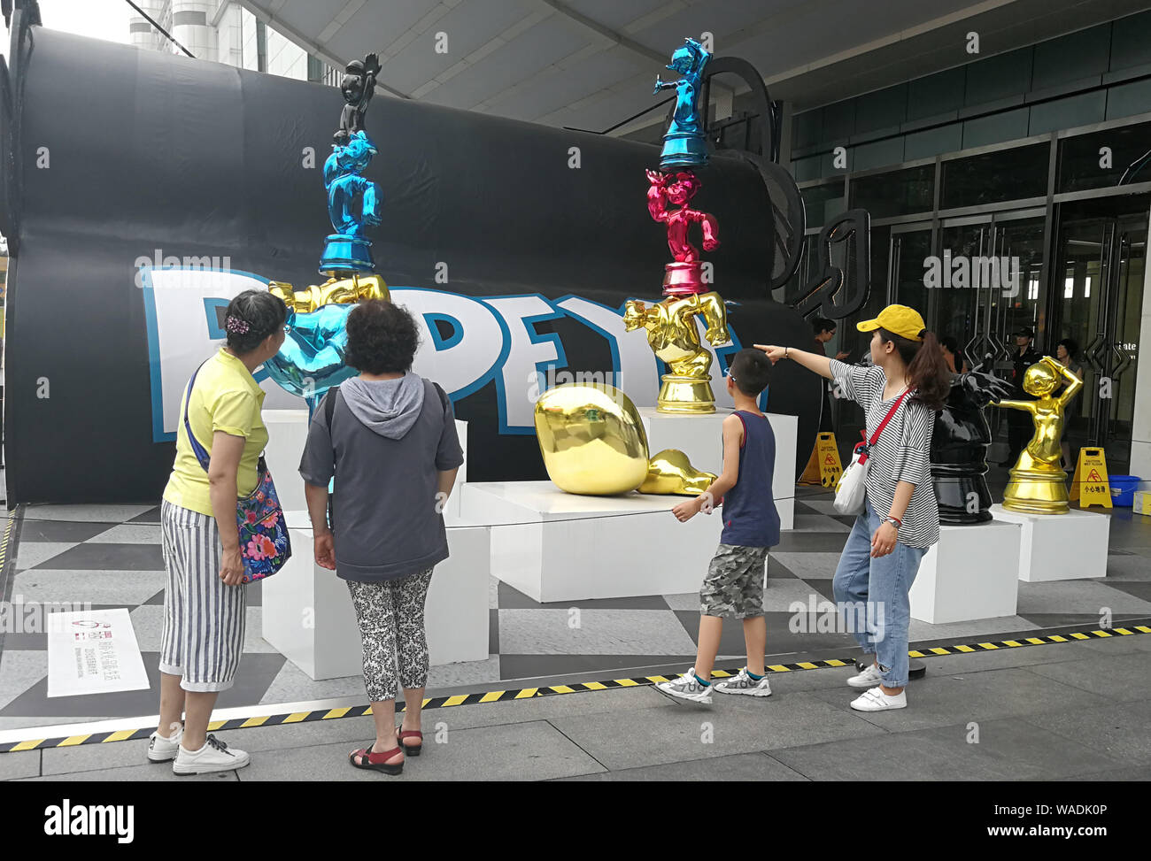 Customers view sculptures featuring cartoon character "Popeye the ...
