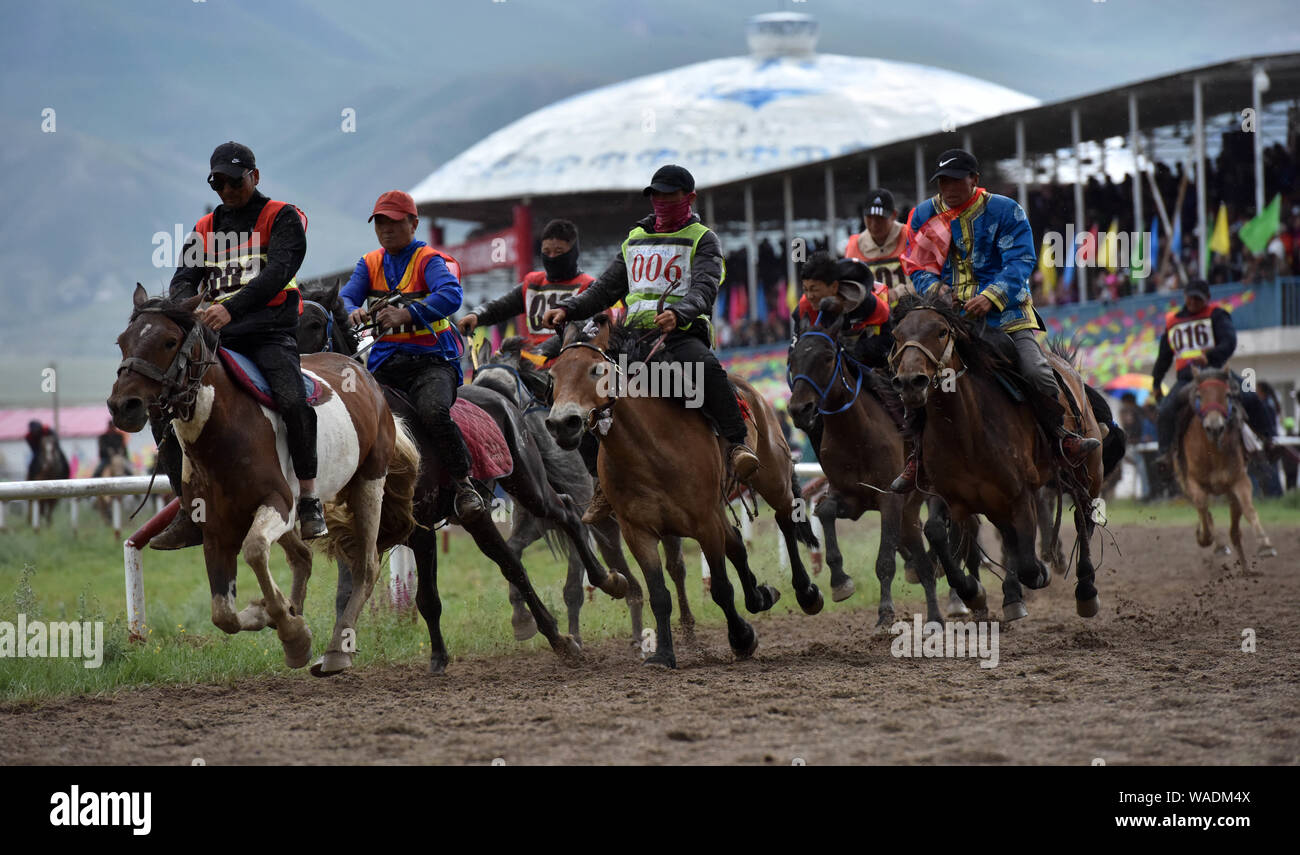 Participants ride horses during the Naadam Festival in Hejing county ...