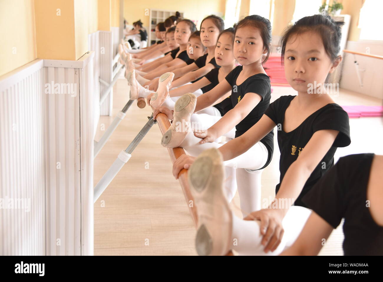 Young girls practice dancing skills during a training session at a ...