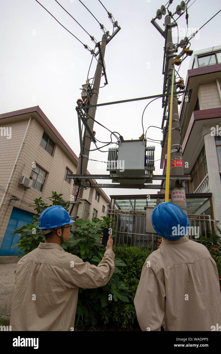 Chinese workers of State Grid Yangzhou Municipal Electric Power Company ...