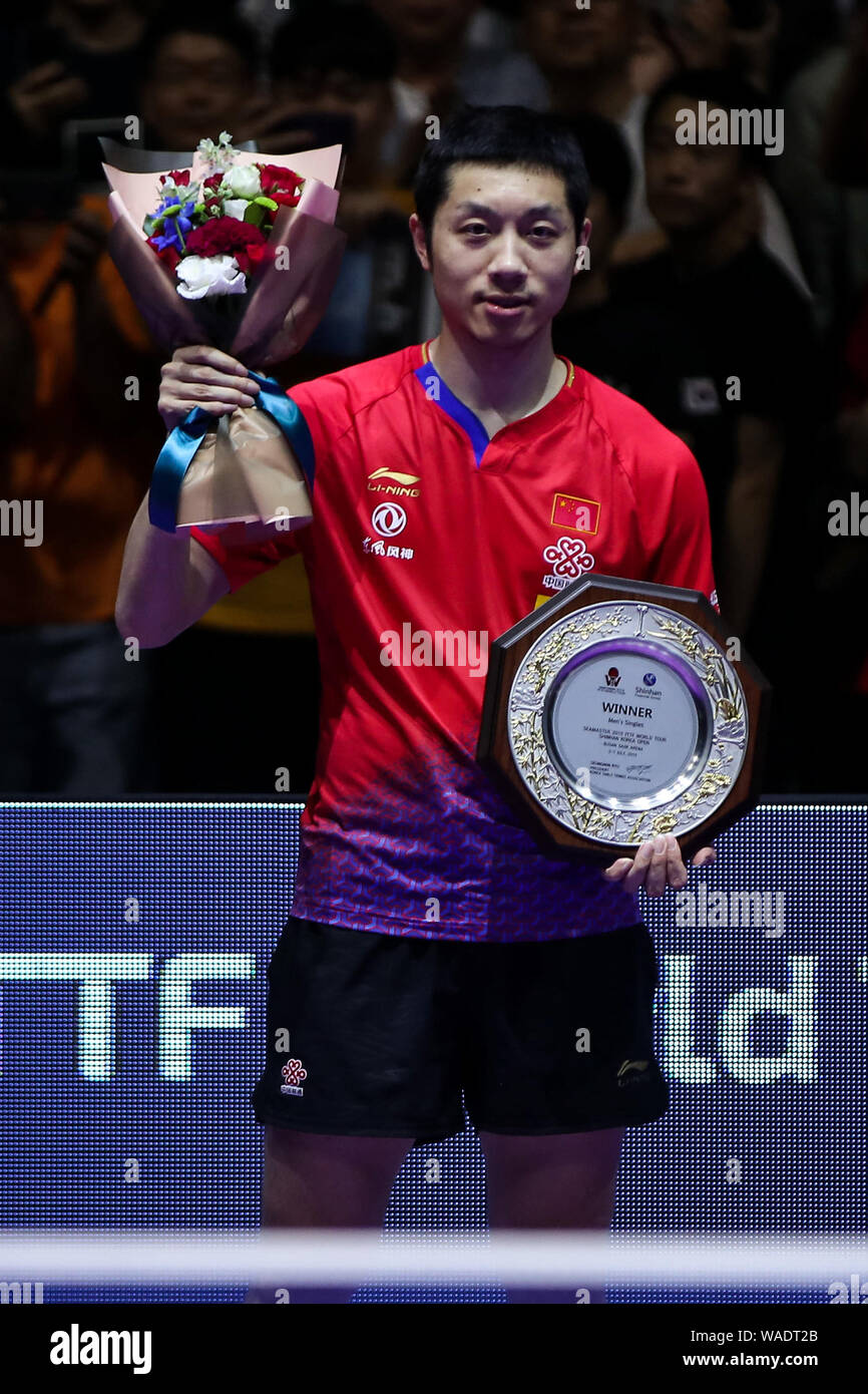 Xu Xin of China poses with his trophy after defeating Ma Long of China ...