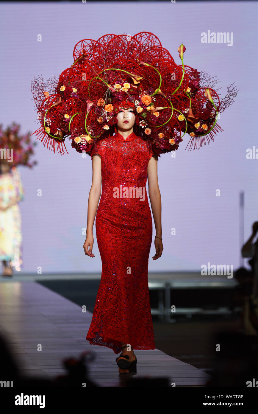 A model displays a new creation decorated with flowers at a floral ...