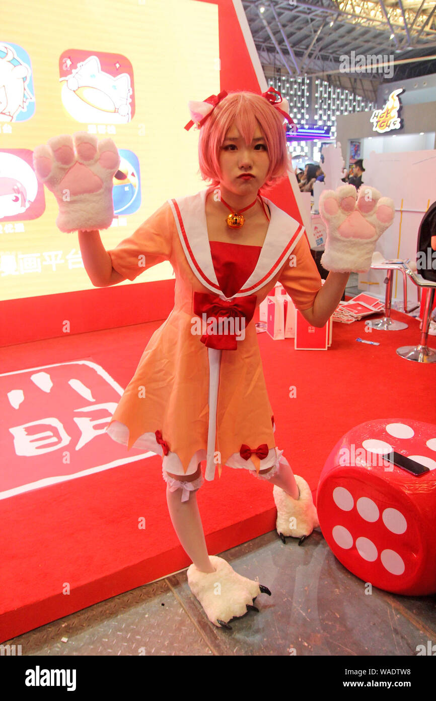 A showgirl dressed in cosplay costume poses during the 15th China ...
