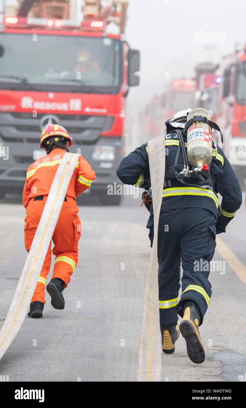 Chinese firefighters take part in the first fire drill at the Beijing ...