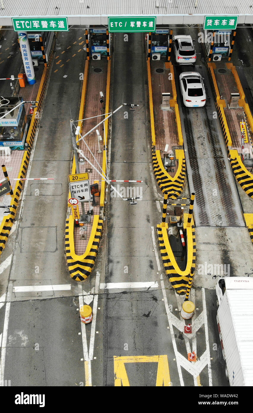 --FILE--Vehicles queue up to pass through a toll station on an ...