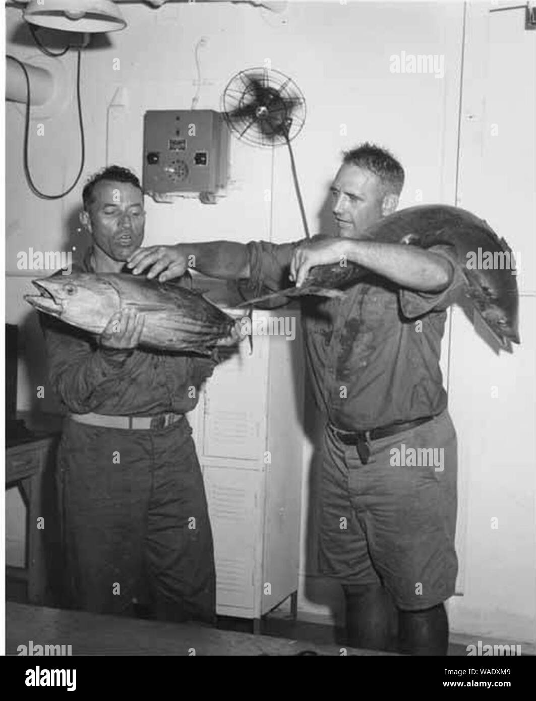Dr Lauren R Donaldson and Mr Clarence F Pautzke displaying fish ...