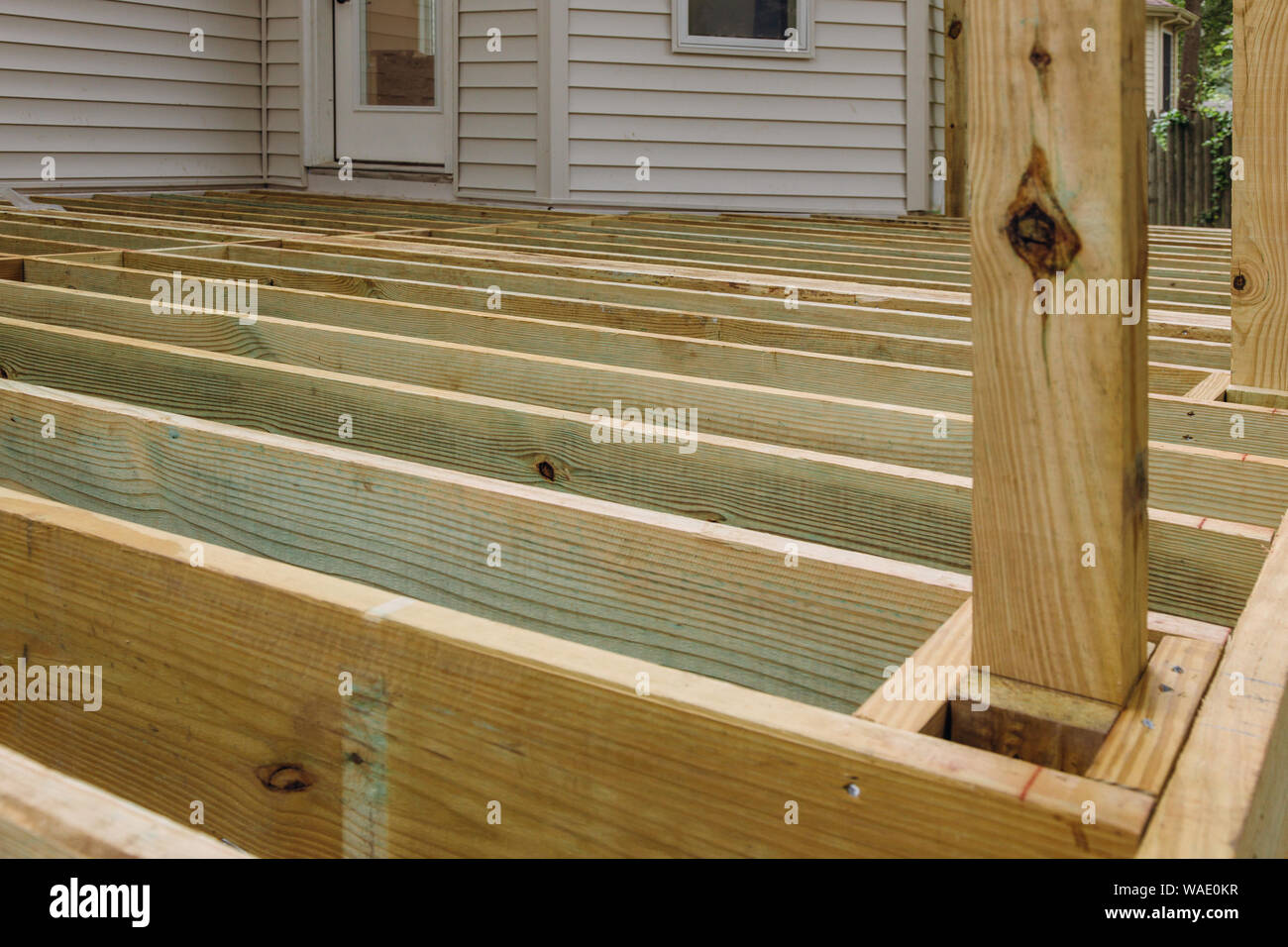 A new wooden, timber deck being constructed. it is on the decking. New ...