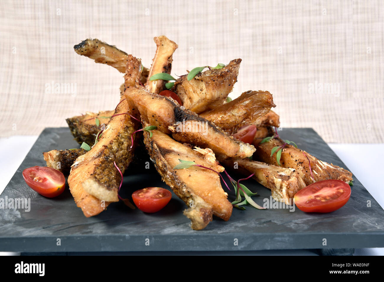 fried fish strips served on stone Stock Photo - Alamy