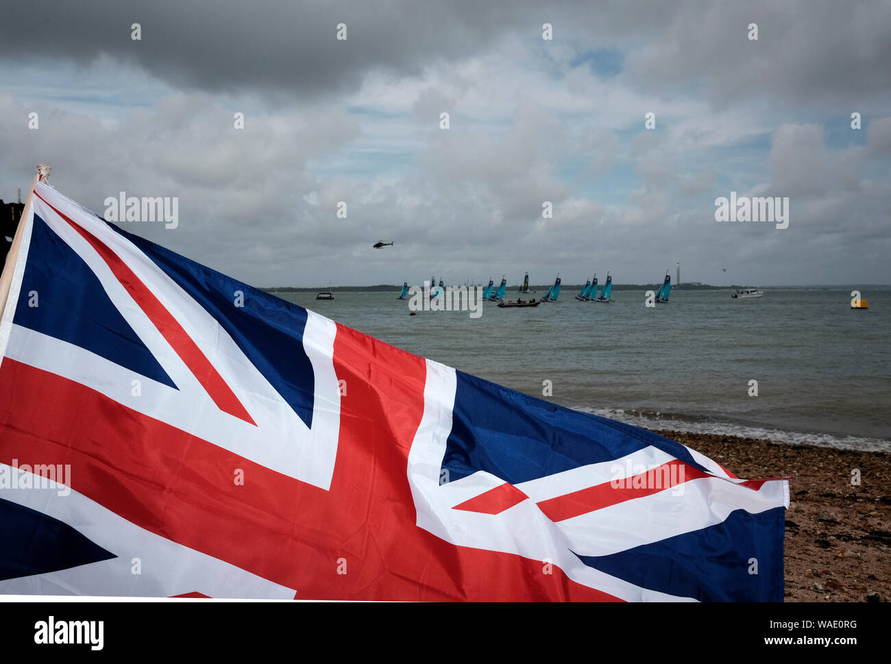 Small double hull yacht racing just off the beach on Cowes seafront on ...