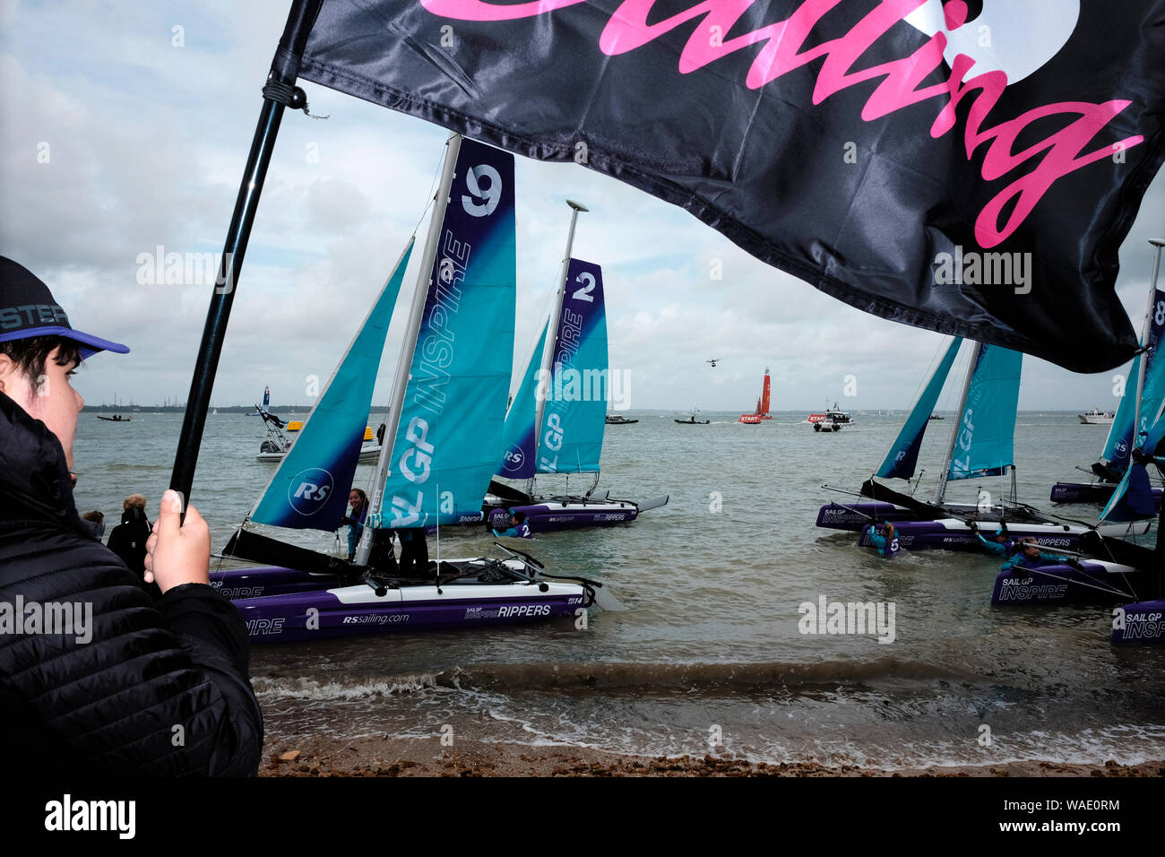 Small double hull yacht racing just off the beach on Cowes seafront on ...