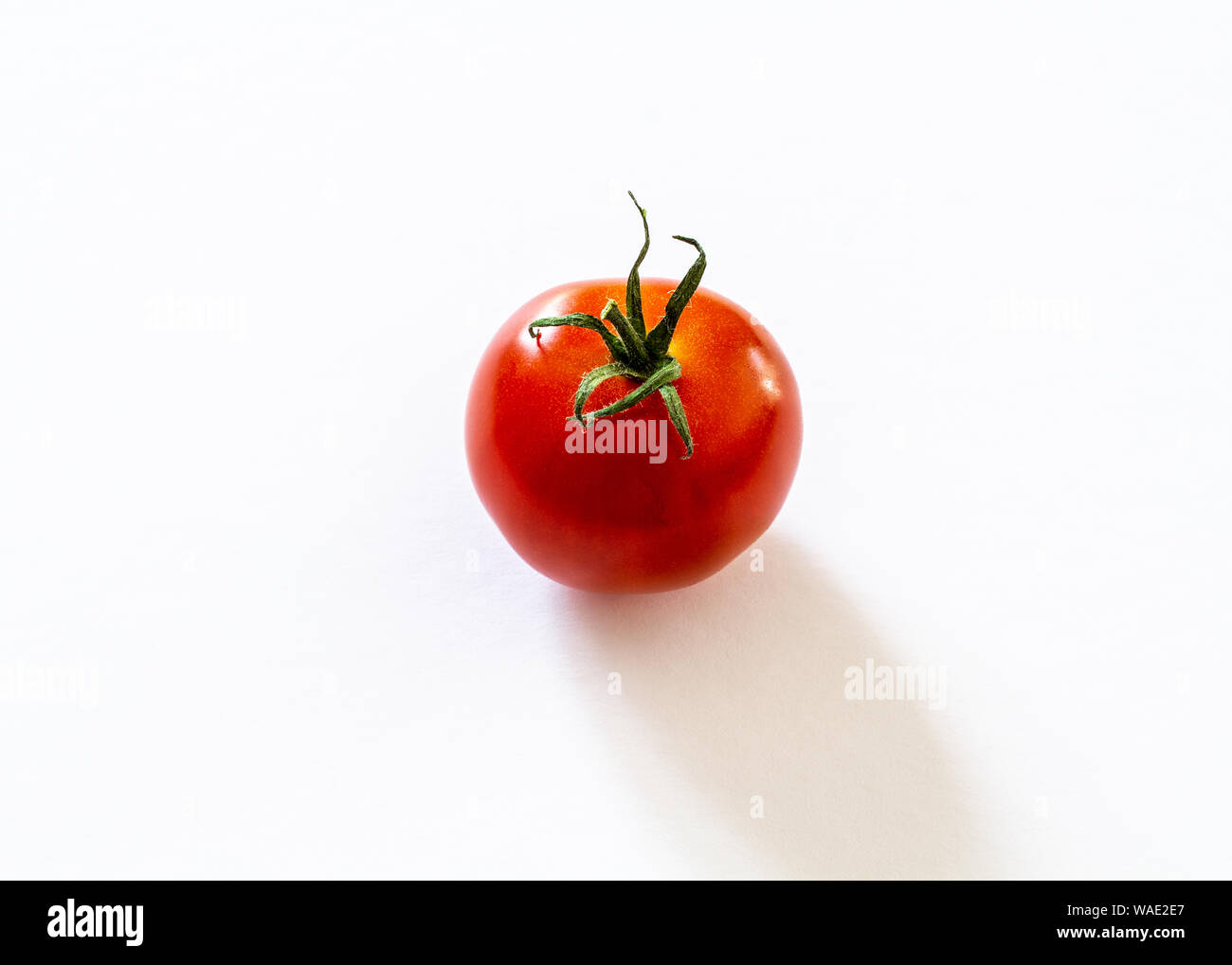 small red cherry tomato on white background Stock Photo - Alamy