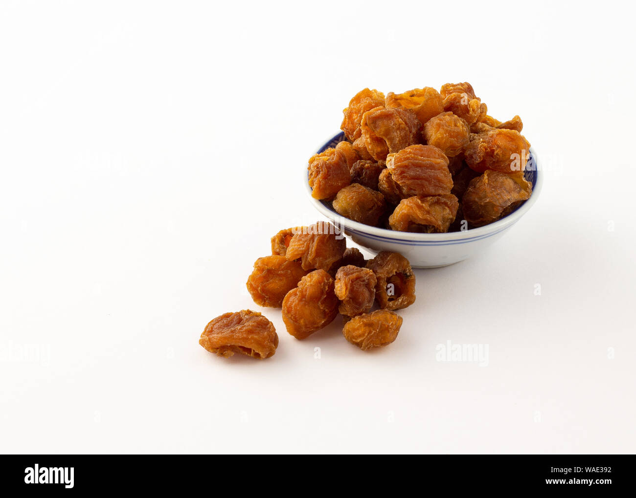 group of dried longan fruit in dish and on white background Stock Photo ...