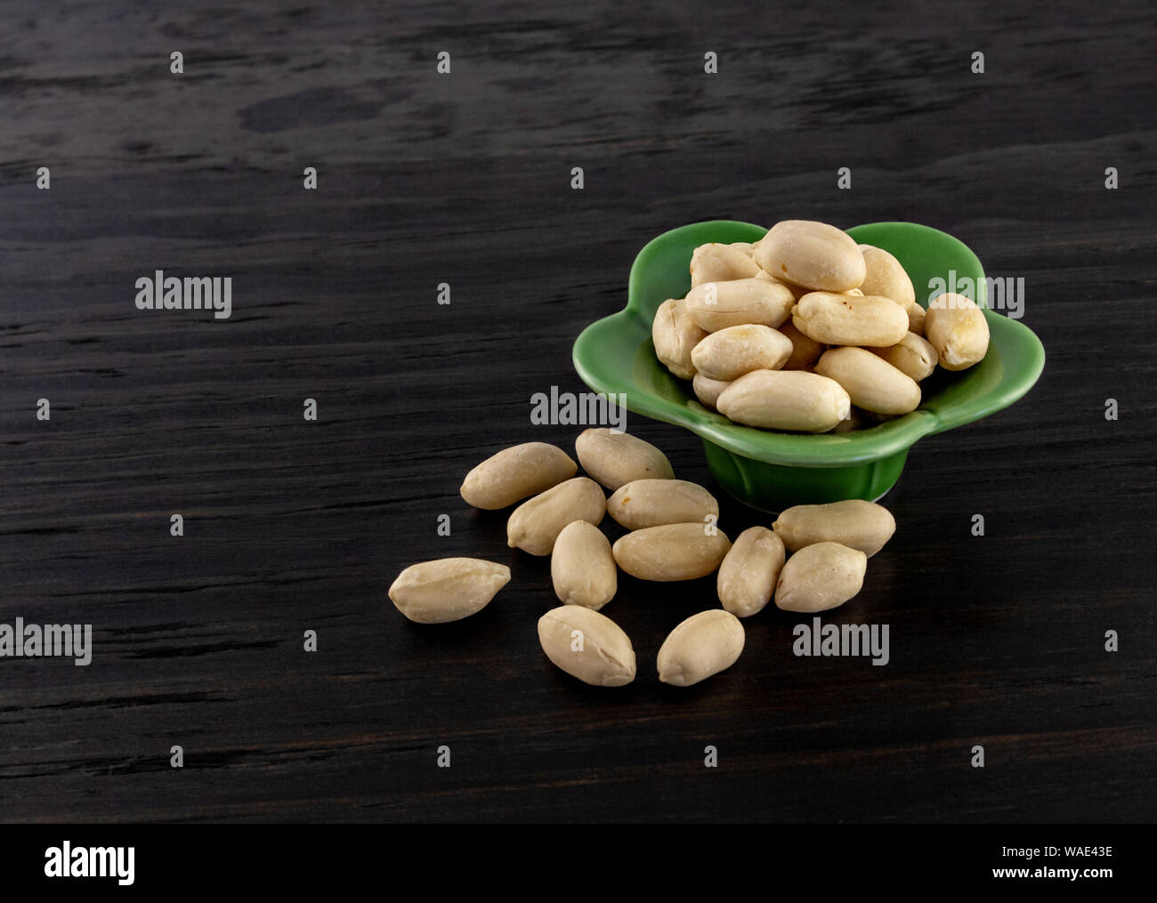 group of raw peanuts in containers on wood background Stock Photo - Alamy