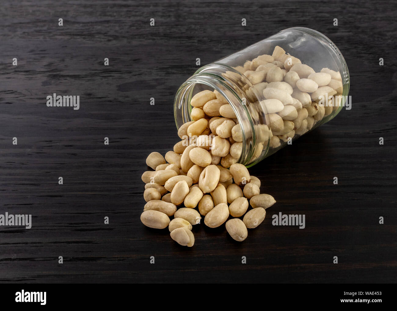 group of raw peanuts in containers on wood background Stock Photo - Alamy