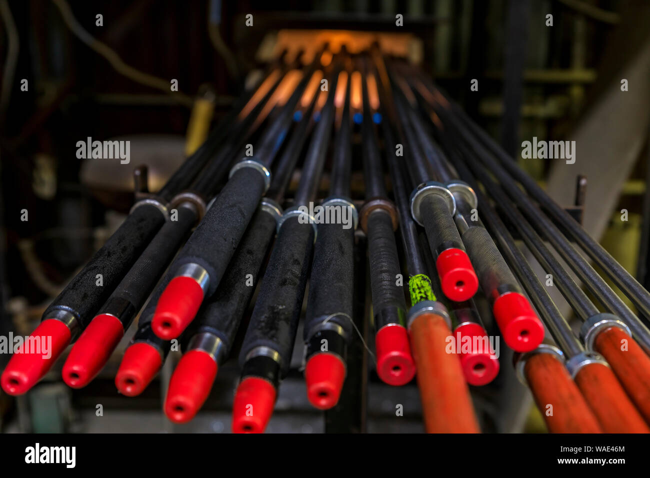 Glass blowing pipes getting warmed up in a traditional furnace for the ...