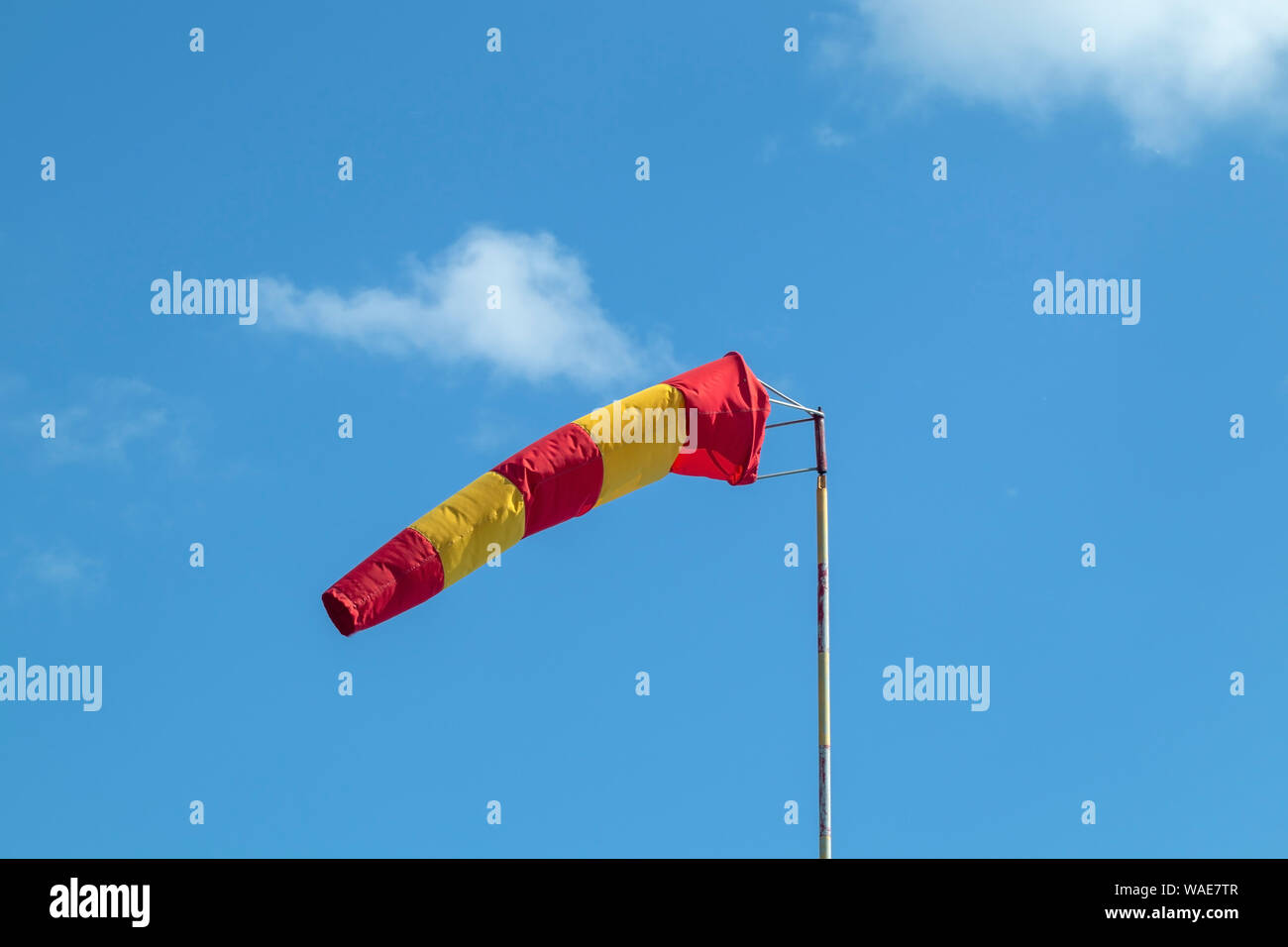 yellow and red windsock against blue sky Stock Photo - Alamy