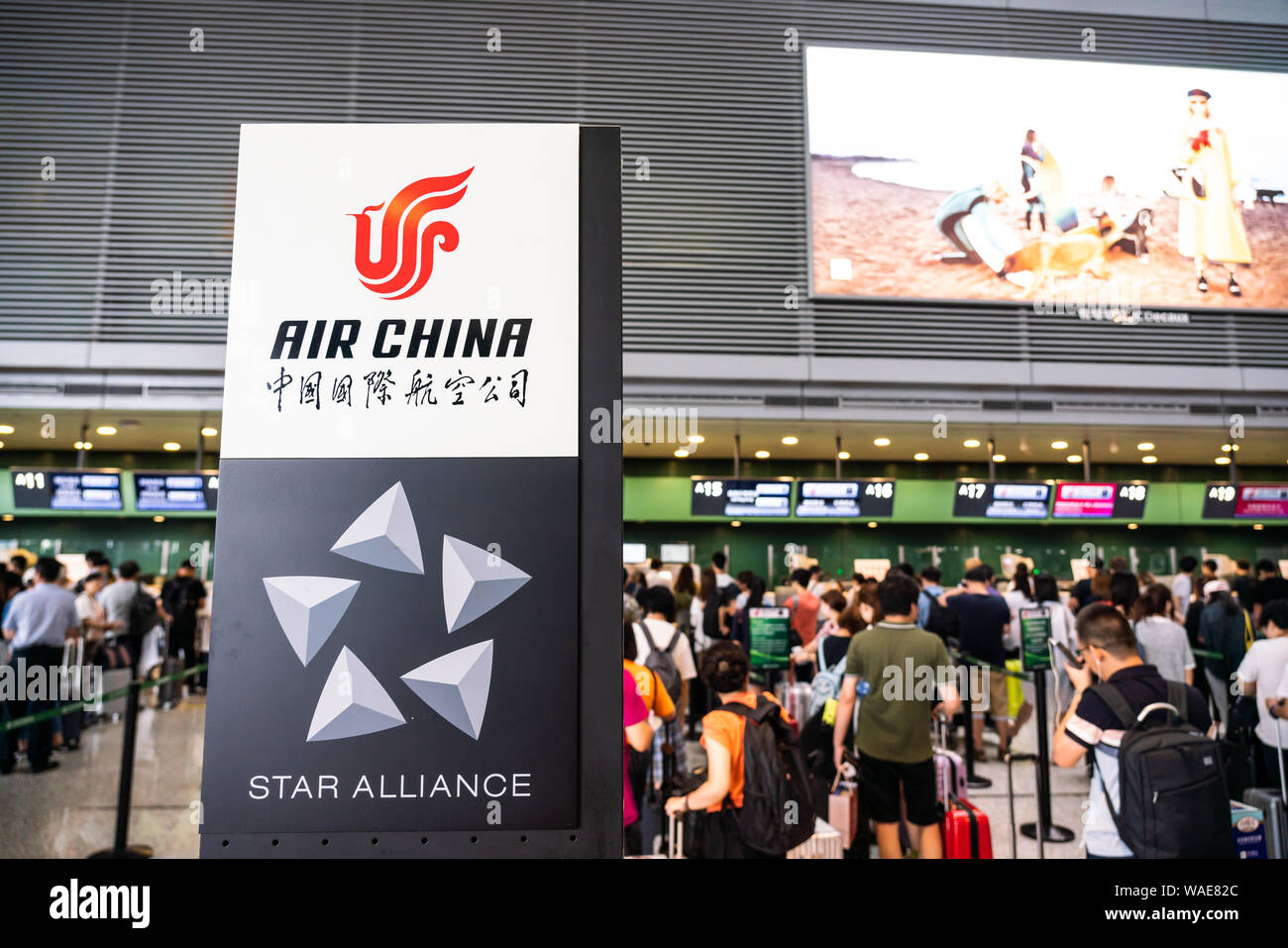 Air China logo and Star Alliance seen in front of the check-in counters ...