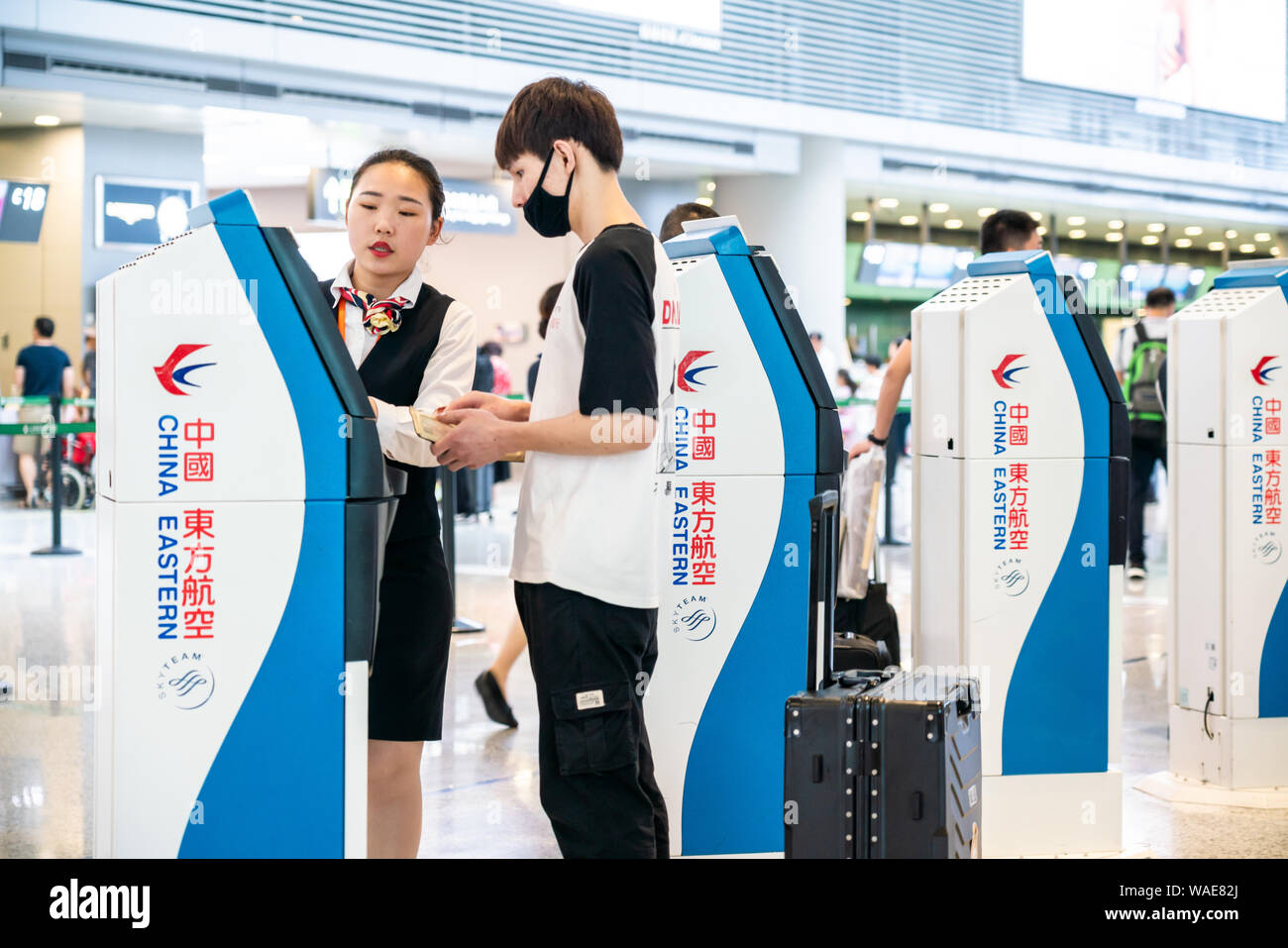 Passengers use the China Eastern Airlines kiosks for airport check-in ...