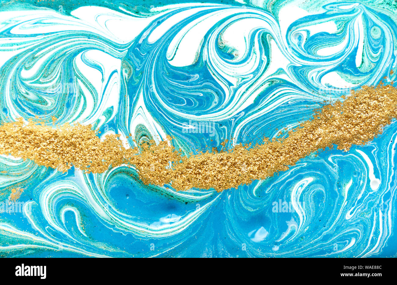 Liquid uneven blue marbling pattern with golden glitter and glare of ...