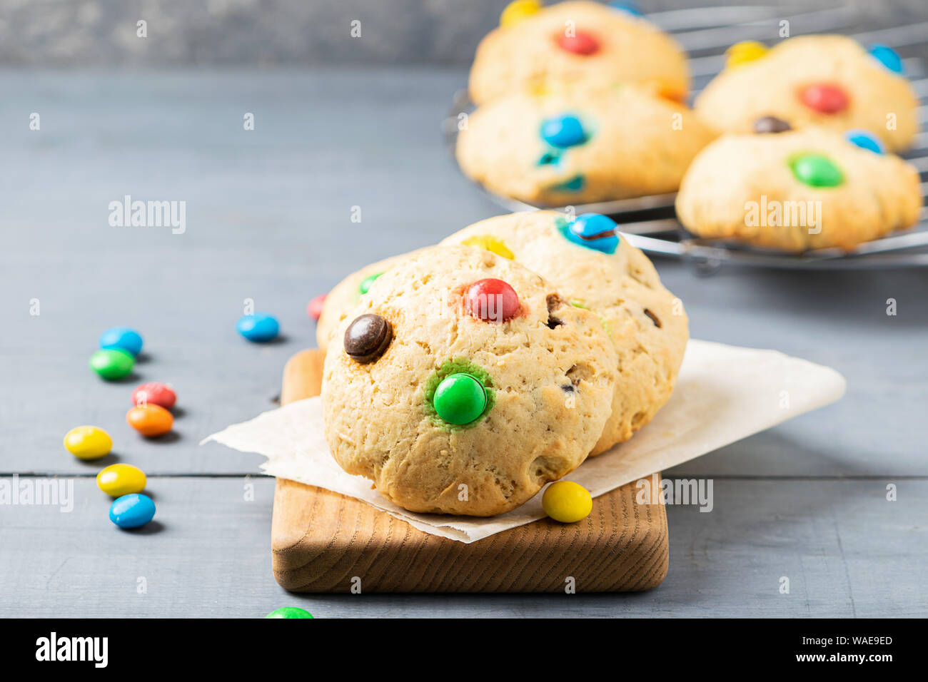 Homemade fresh cookies decorated with colored round sweets on a gray ...