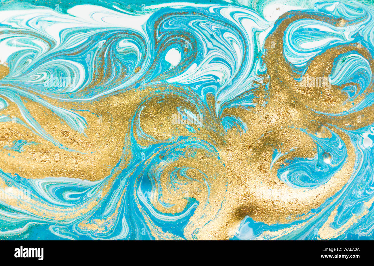 Liquid uneven blue marbling pattern with golden glitter and glare of ...