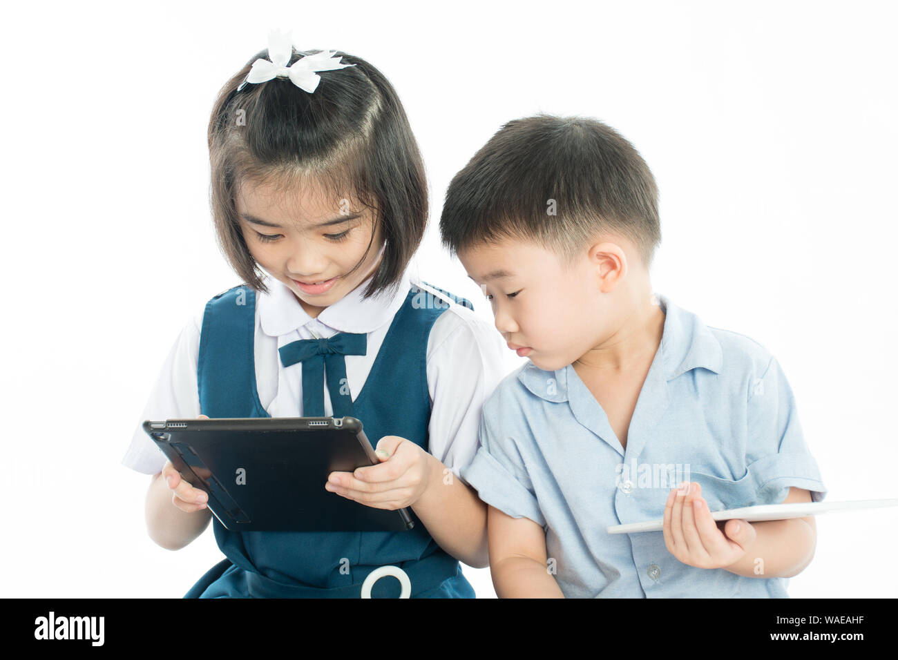 Boy and girl learning by tablet computer Stock Photo - Alamy
