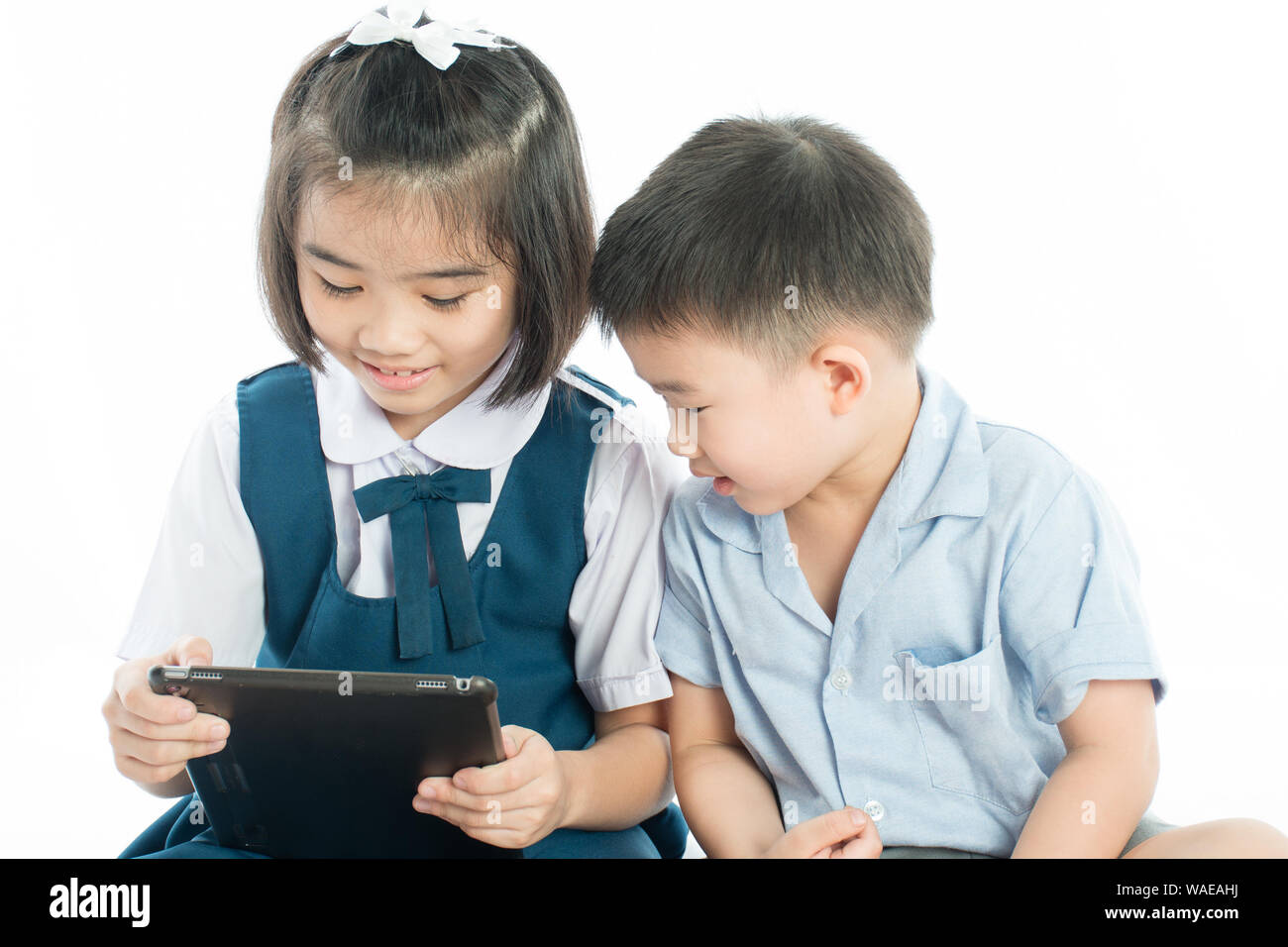 Boy and girl learning by tablet computer Stock Photo - Alamy