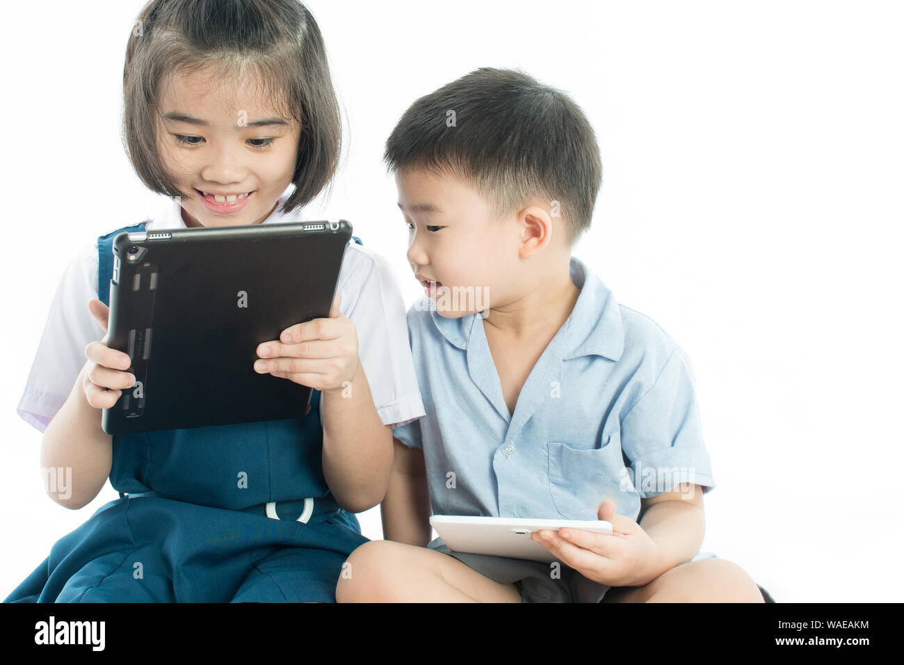 Boy and girl learning by tablet computer Stock Photo - Alamy