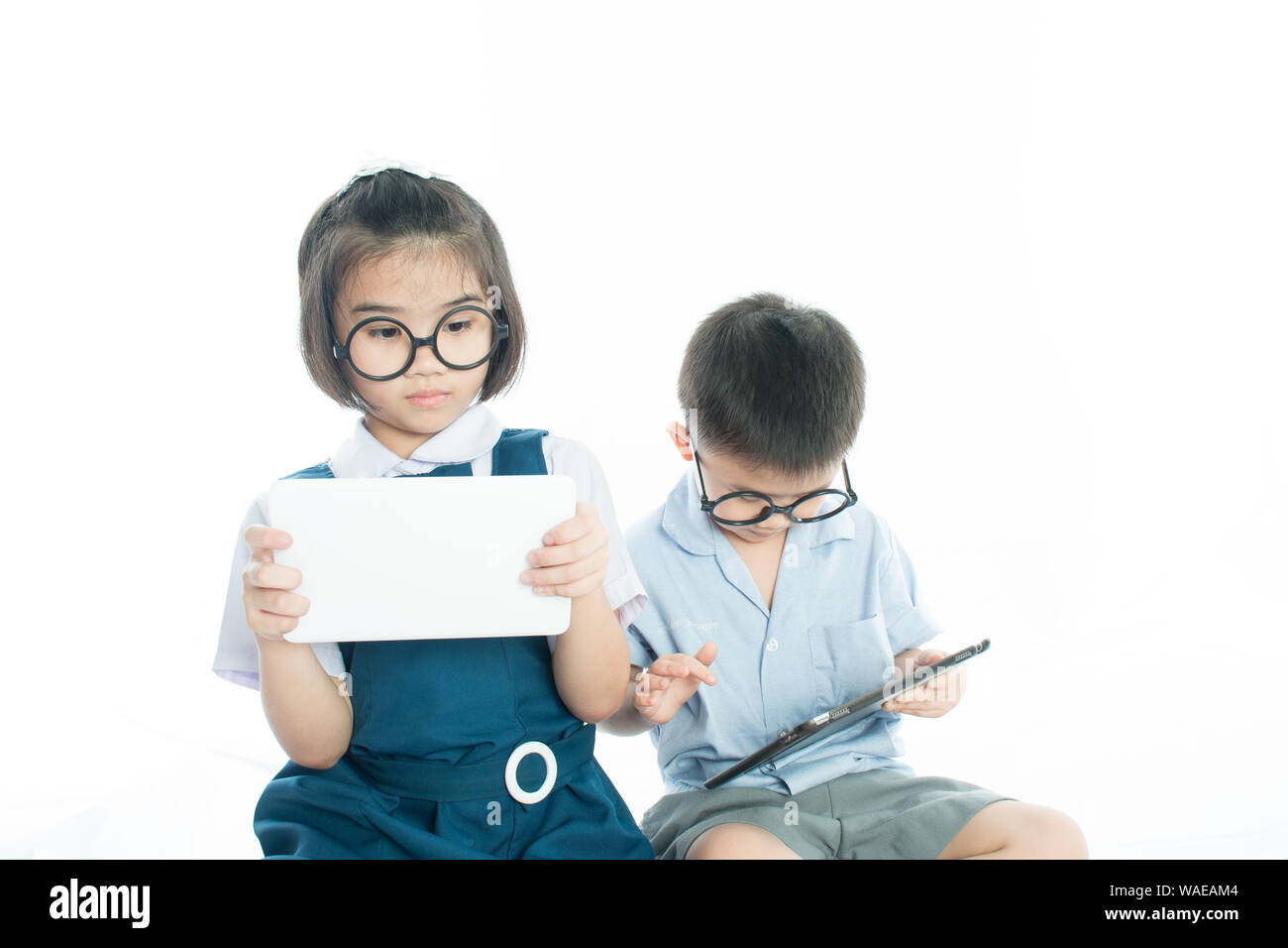 Boy and girl learning by tablet computer Stock Photo - Alamy