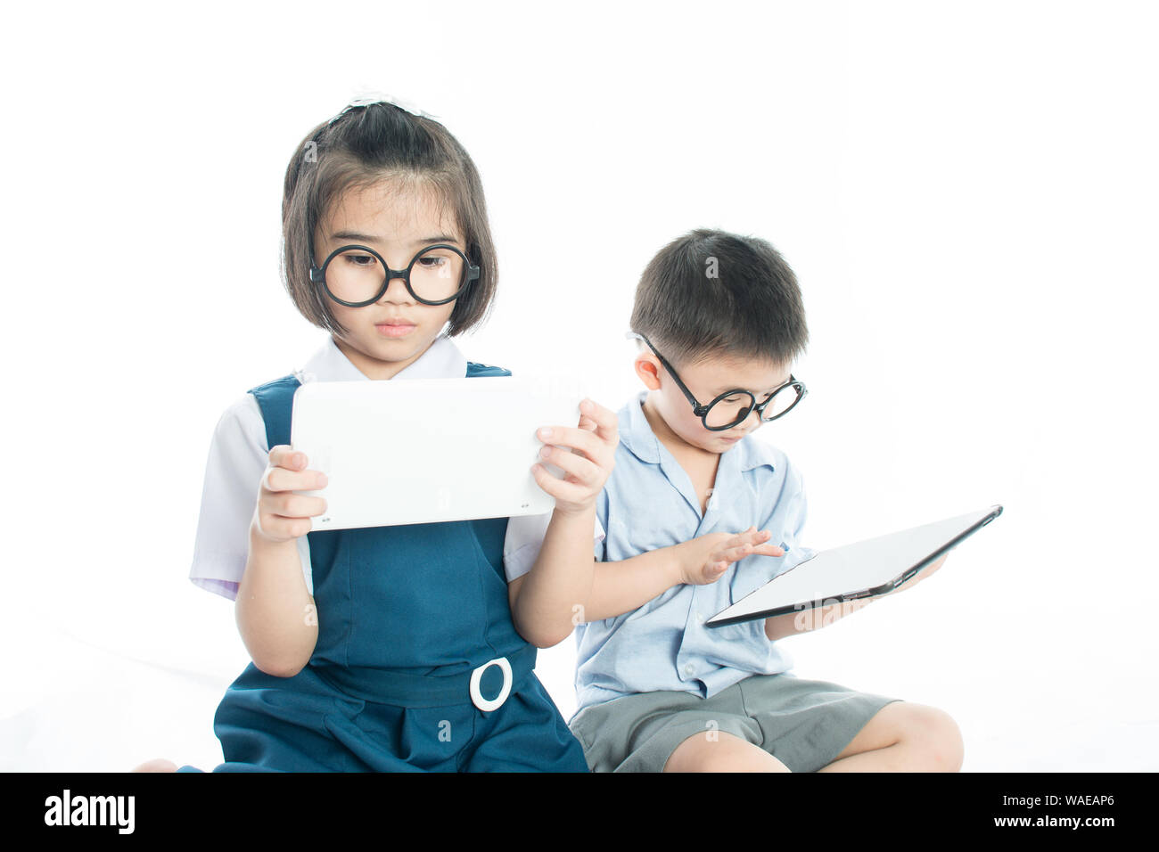 Boy and girl learning by tablet computer Stock Photo - Alamy