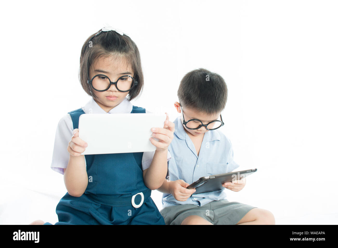 Boy and girl learning by tablet computer Stock Photo - Alamy