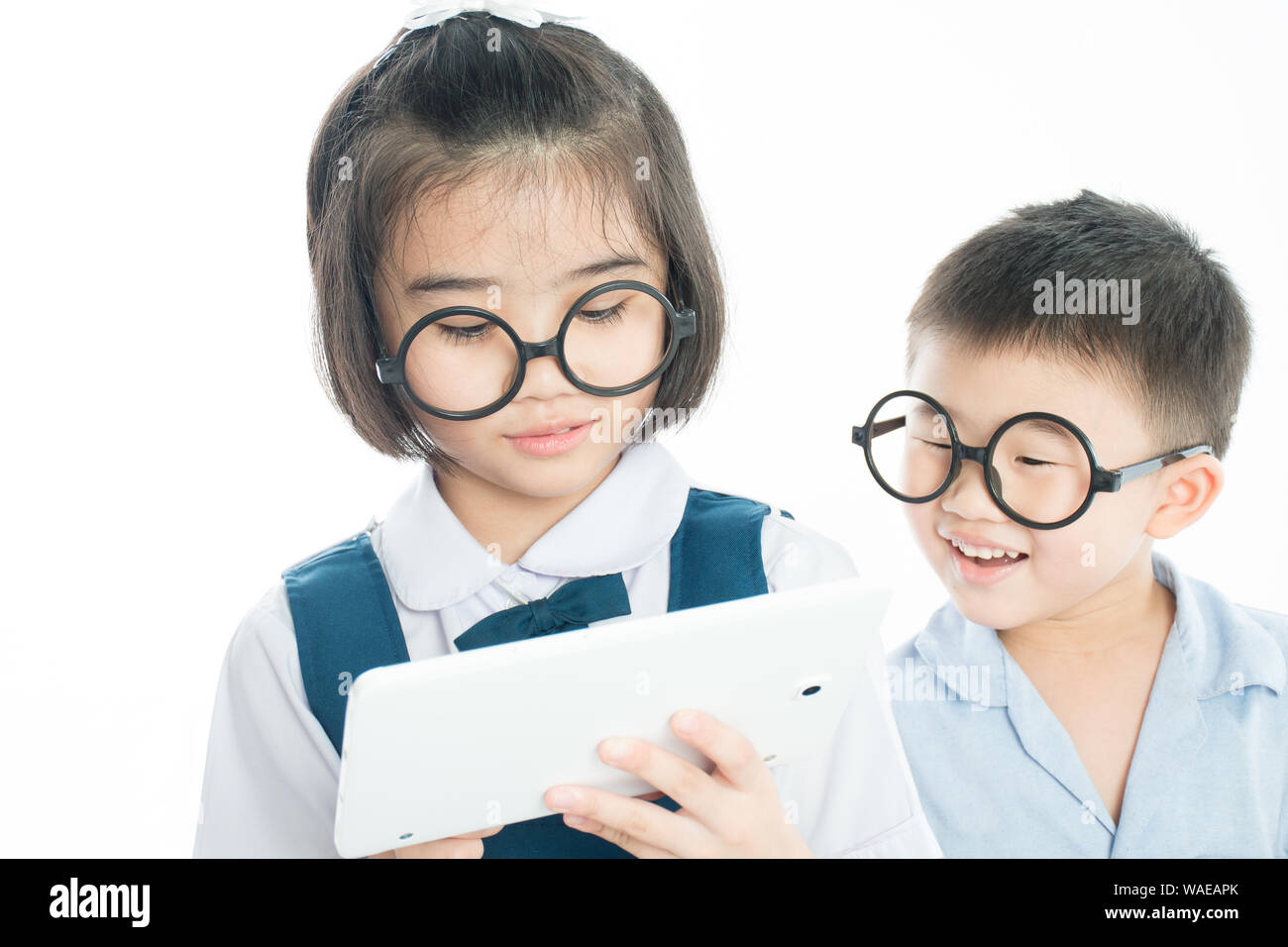Boy and girl learning by tablet computer Stock Photo - Alamy