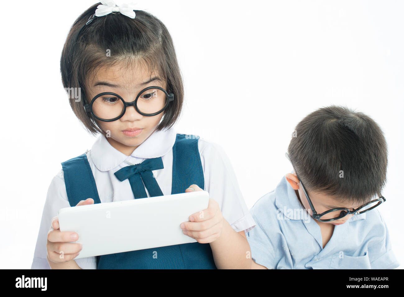 Boy and girl learning by tablet computer Stock Photo - Alamy