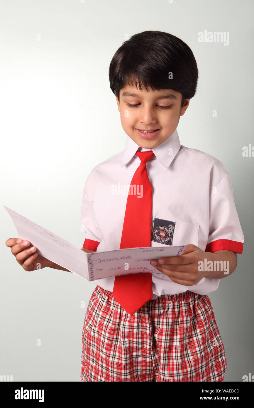 Schoolboy looking at report card Stock Photo - Alamy