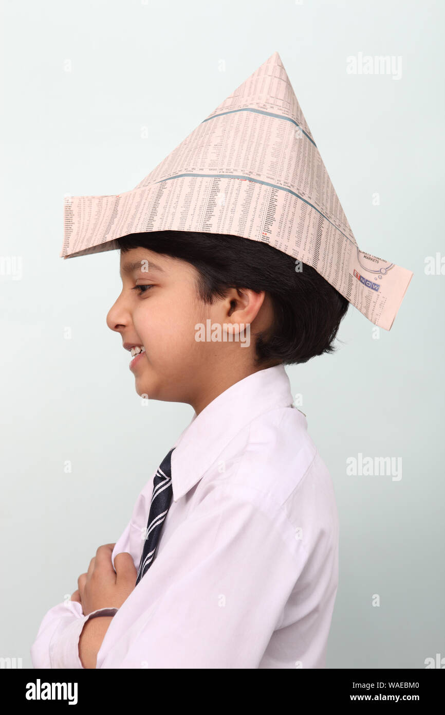 Side profile of schoolboy wearing newspaper hat Stock Photo - Alamy