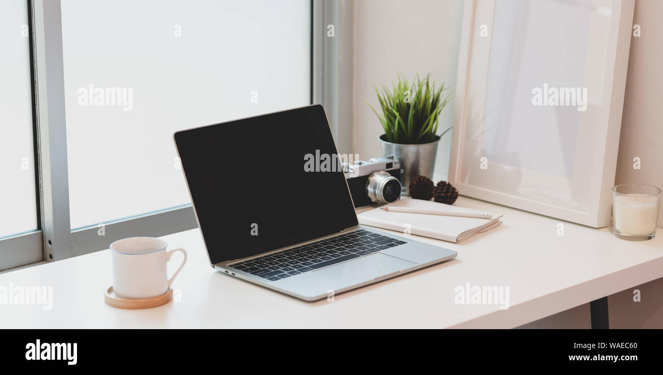 Contemporary photography workplace with laptop computer and mock up ...