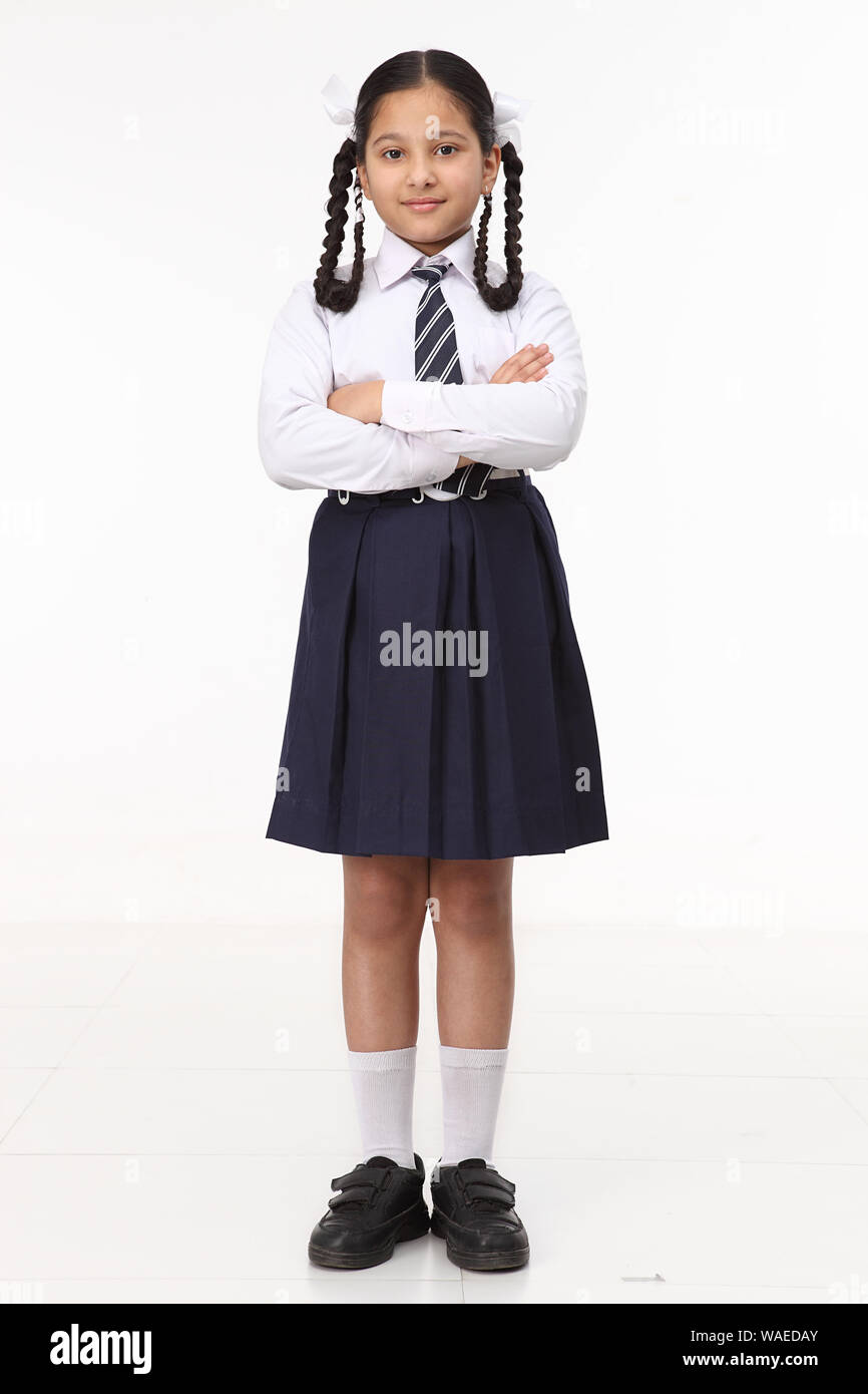 Schoolgirl standing with her arms crossed Stock Photo - Alamy