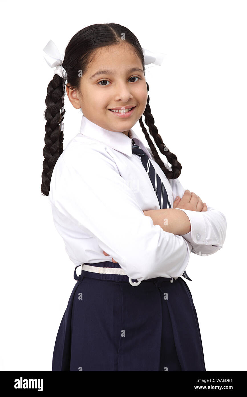 Schoolgirl standing with her arms crossed and smiling Stock Photo - Alamy