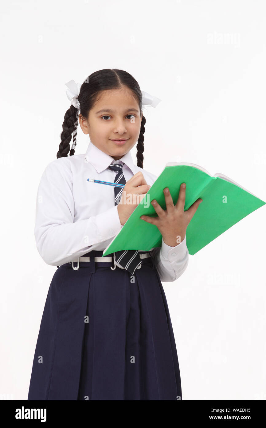 Indian girl writing in notebook hi-res stock photography and images - Alamy