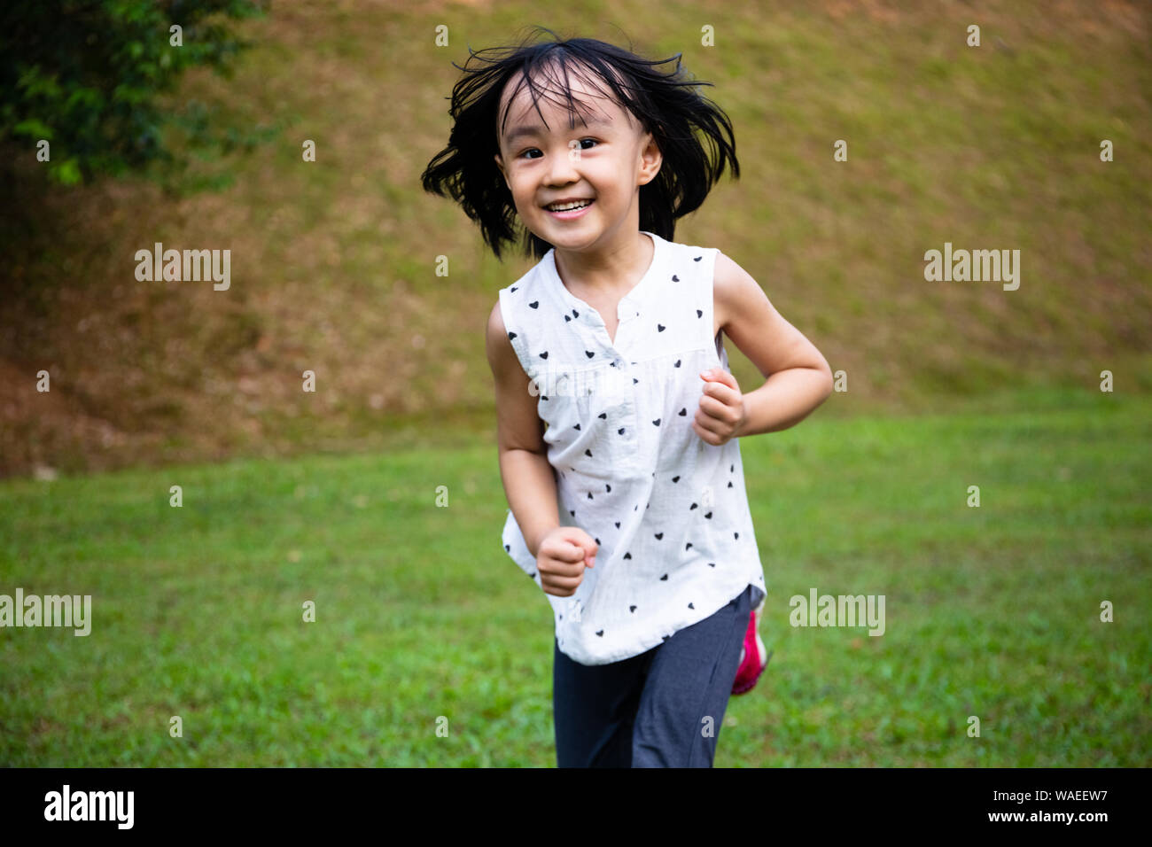 Asian Little Chinese Girl running happily at the outdoor park Stock ...