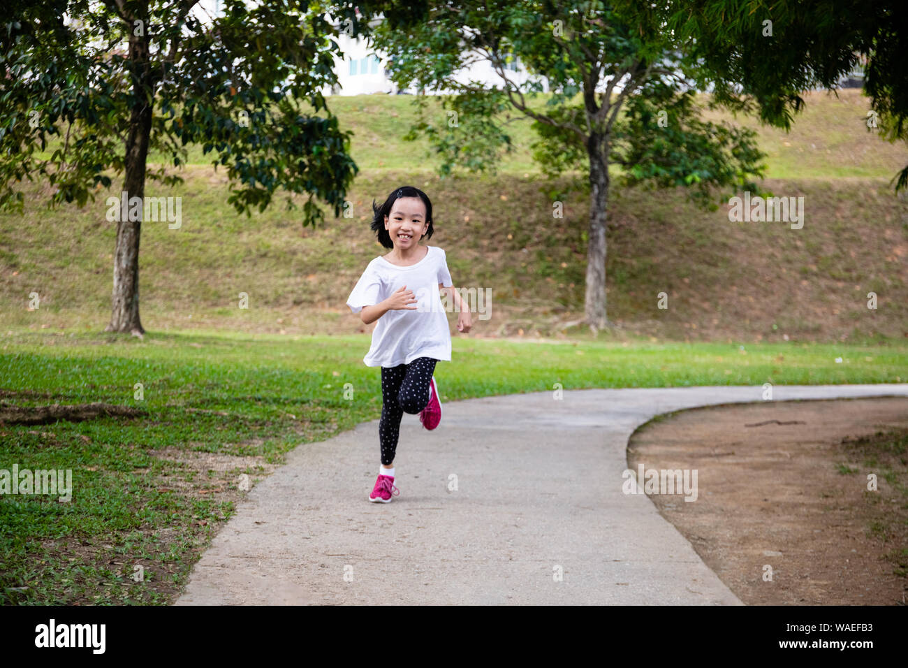 Asian Little Chinese Girl running happily at the outdoor park Stock ...
