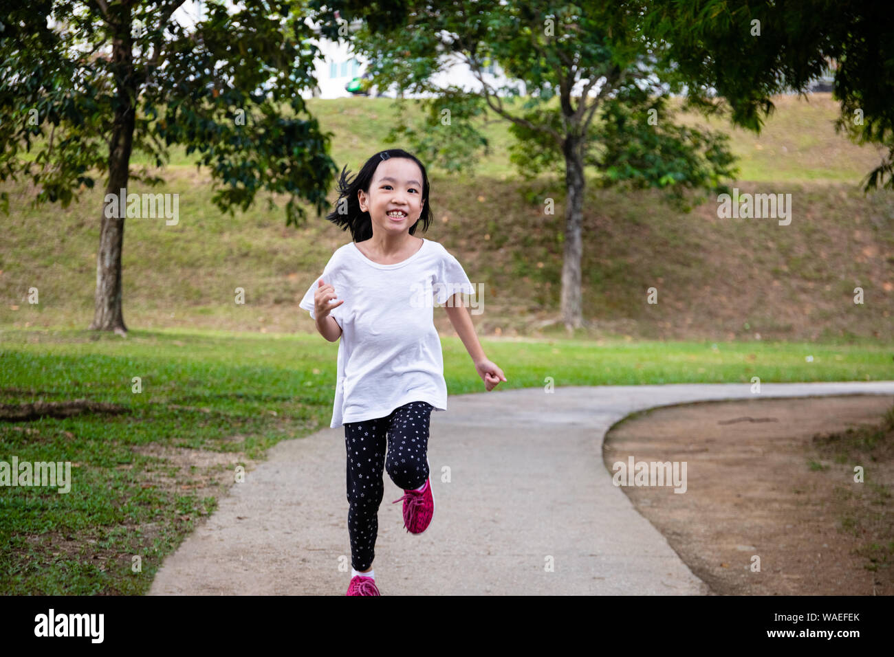 Asian Little Chinese Girl running happily at the outdoor park Stock ...