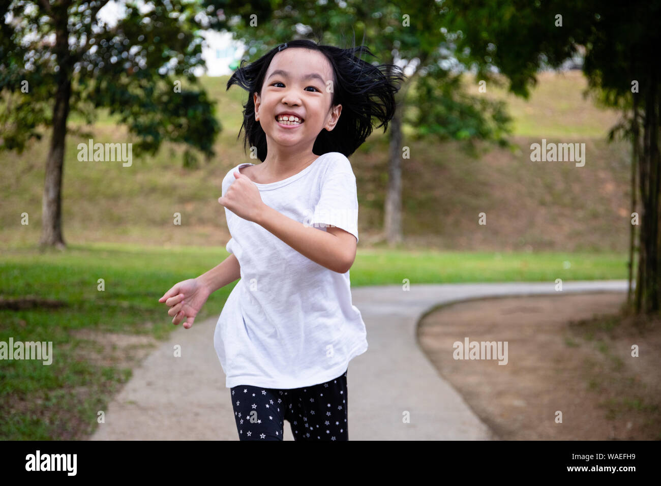 Asian Little Chinese Girl running happily at the outdoor park Stock ...